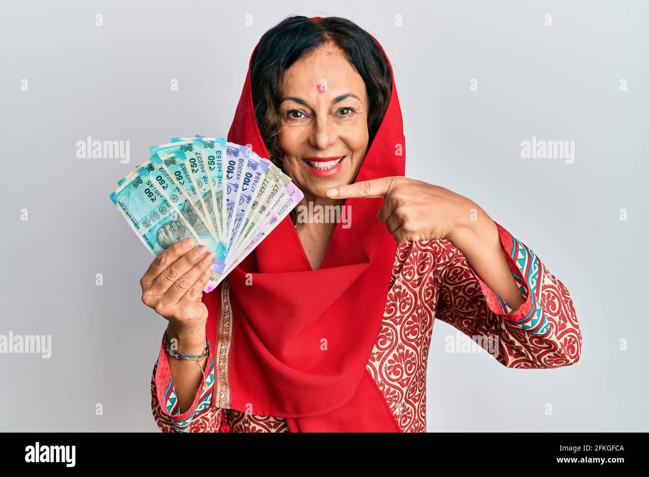 Middle age hispanic woman wearing traditional indian clothes and ...