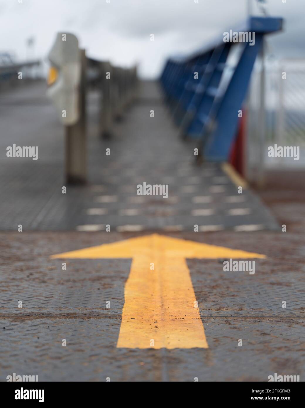 Yellow arrow pointing towards a port ramp Stock Photo - Alamy