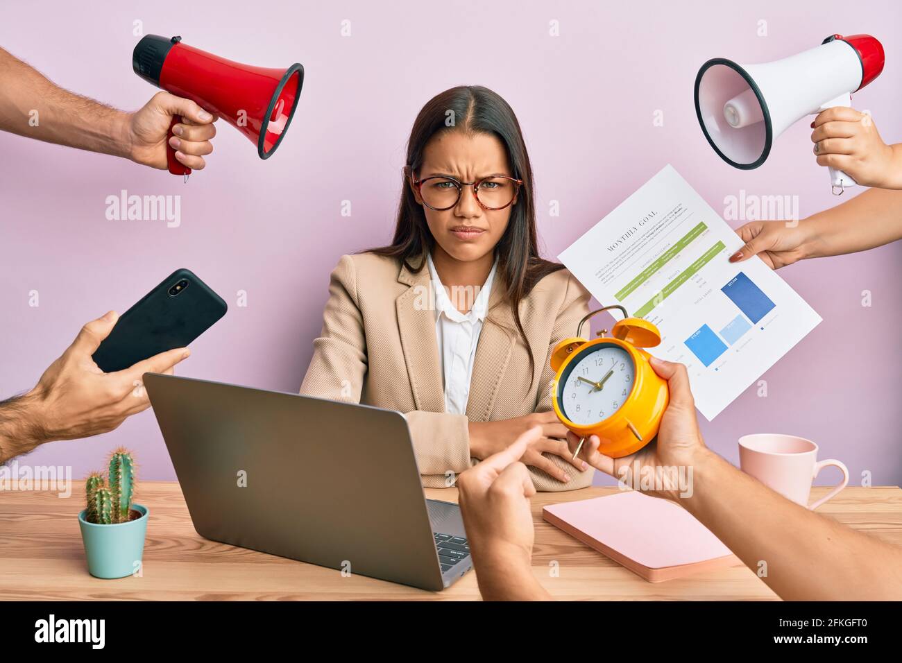 Beautiful hispanic woman working at the office under stress skeptic and ...