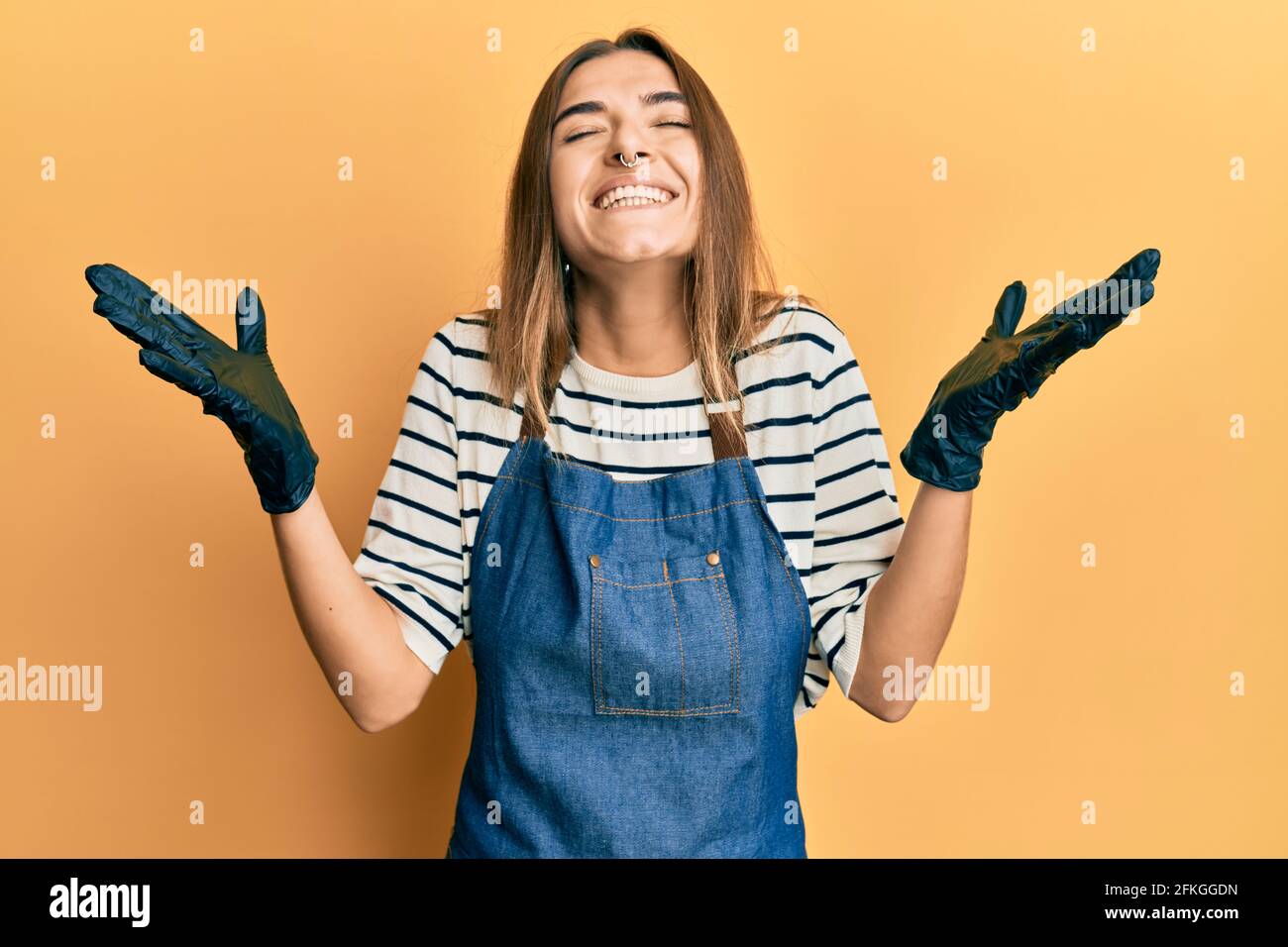 Young hispanic woman wearing barber apron celebrating mad and crazy for ...