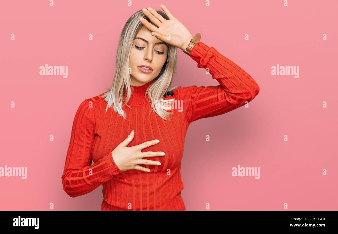 Beautiful blonde woman wearing casual clothes touching forehead for ...
