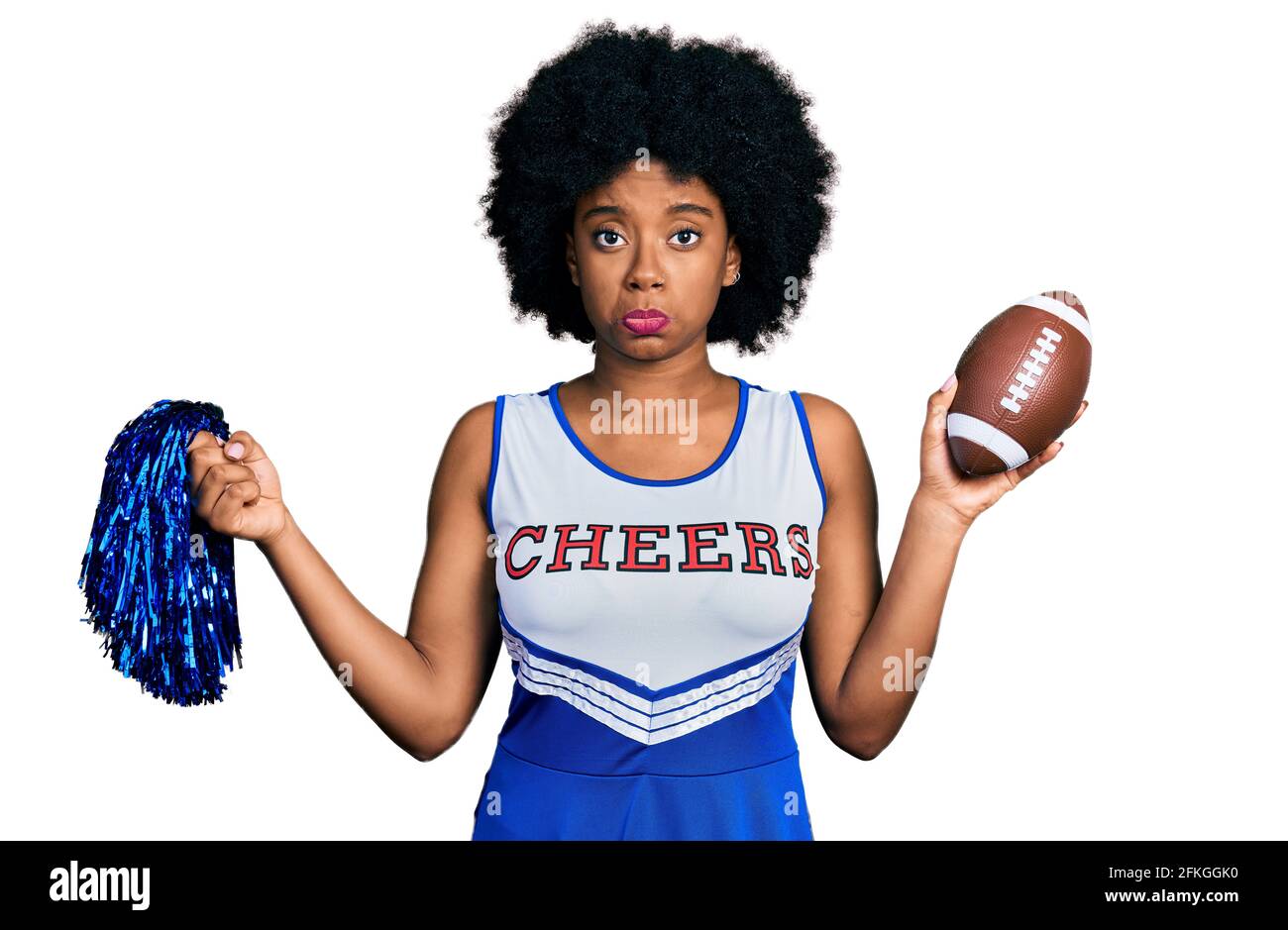Young african american woman wearing cheerleader uniform holding pompom ...