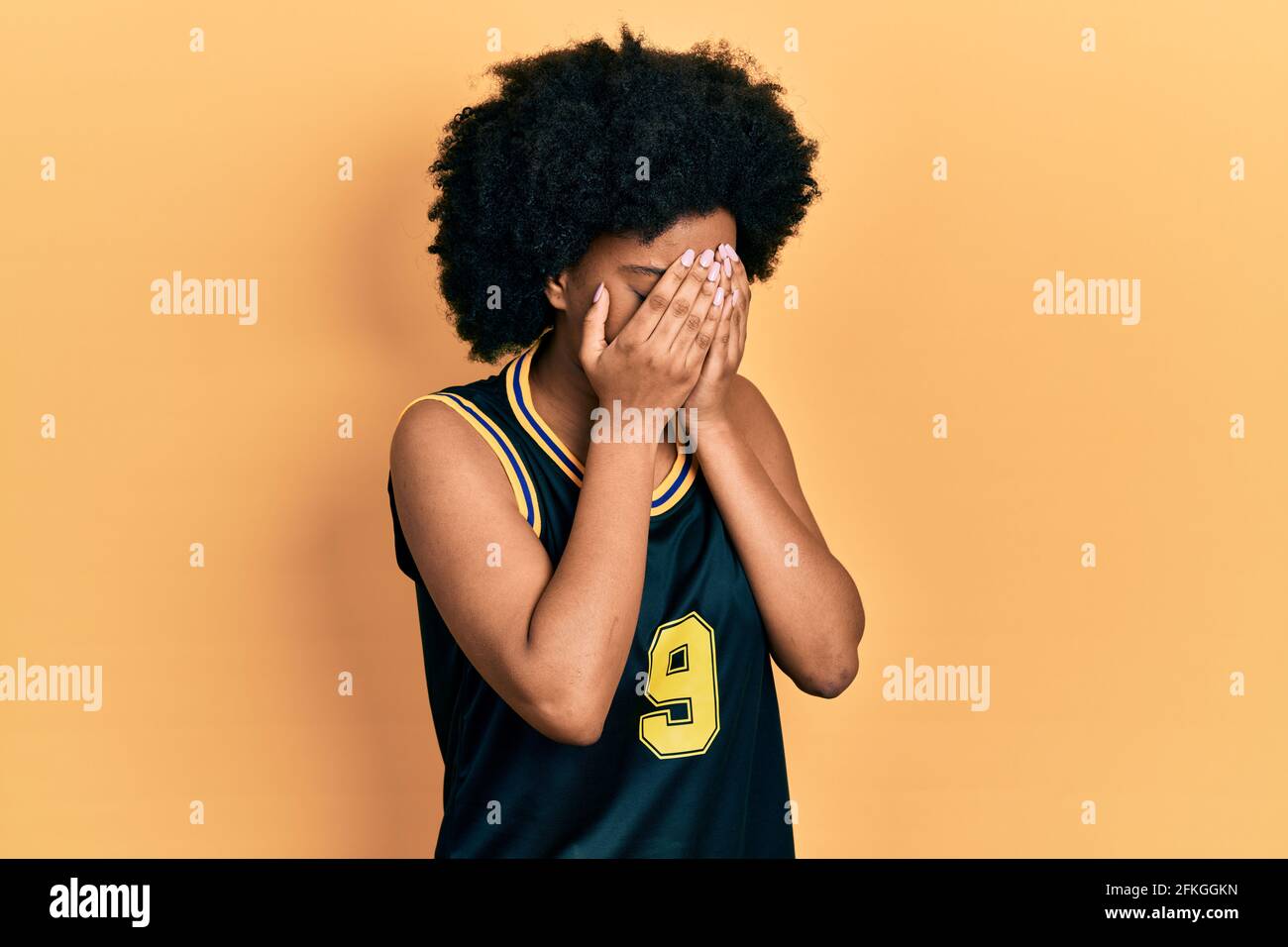 Young african american woman wearing basketball uniform with sad ...