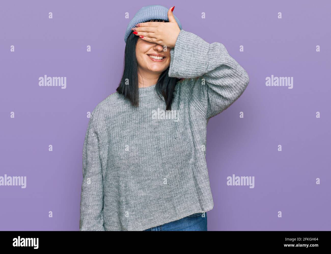 Young hispanic woman wearing cute wool cap smiling and laughing with ...