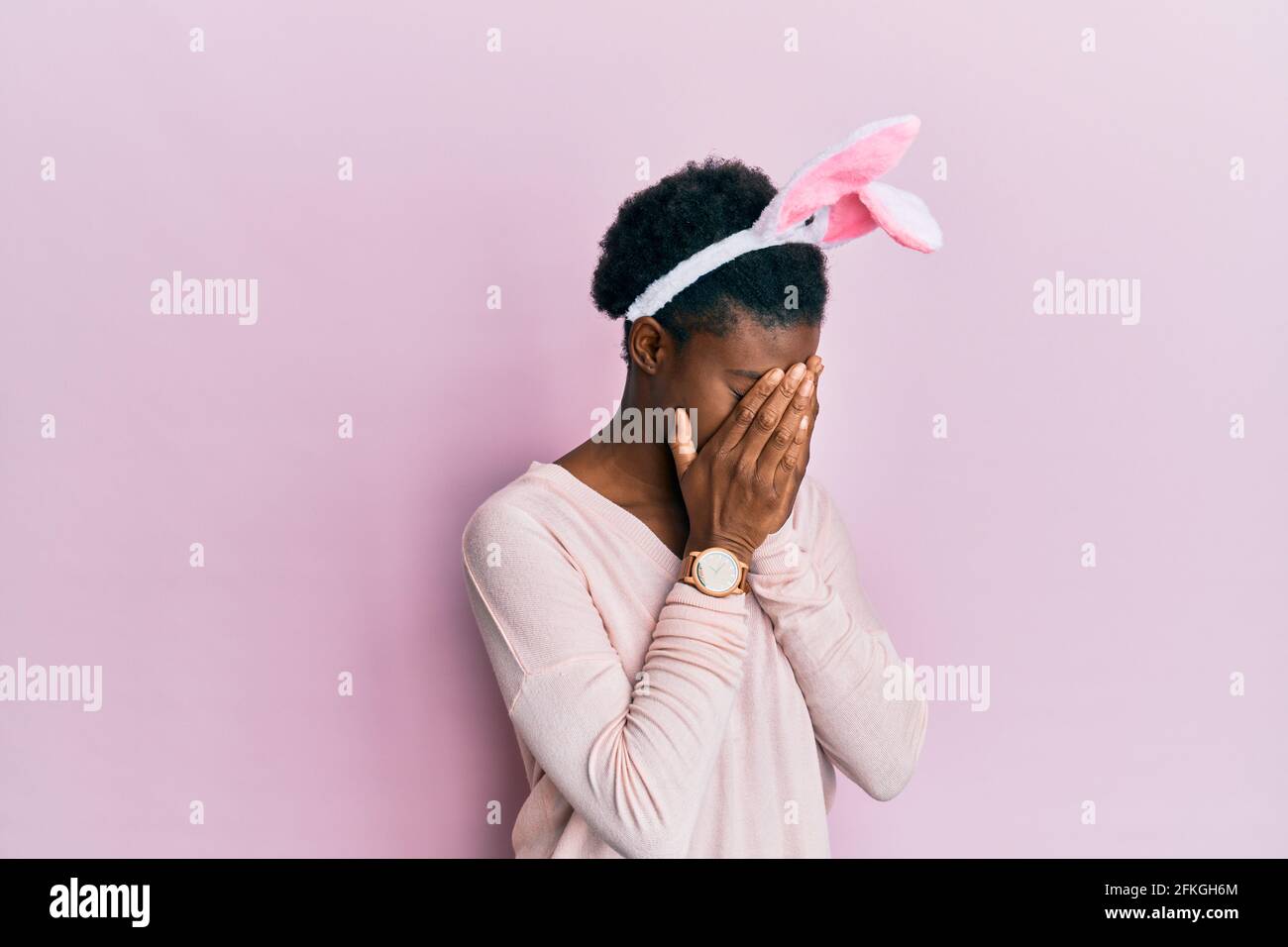 Young african american girl wearing cute easter bunny ears with sad ...