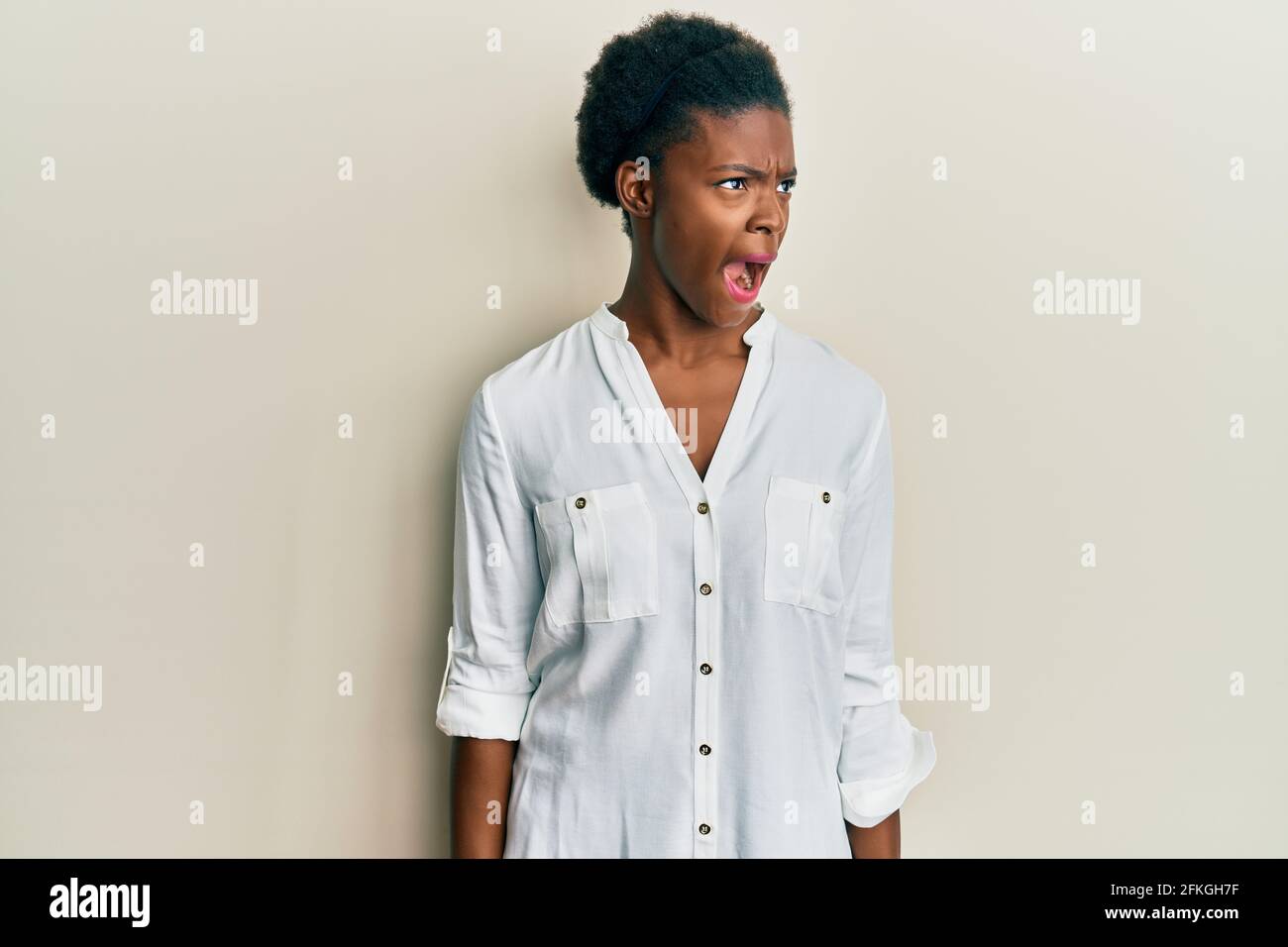 Young african american girl wearing casual clothes angry and mad ...