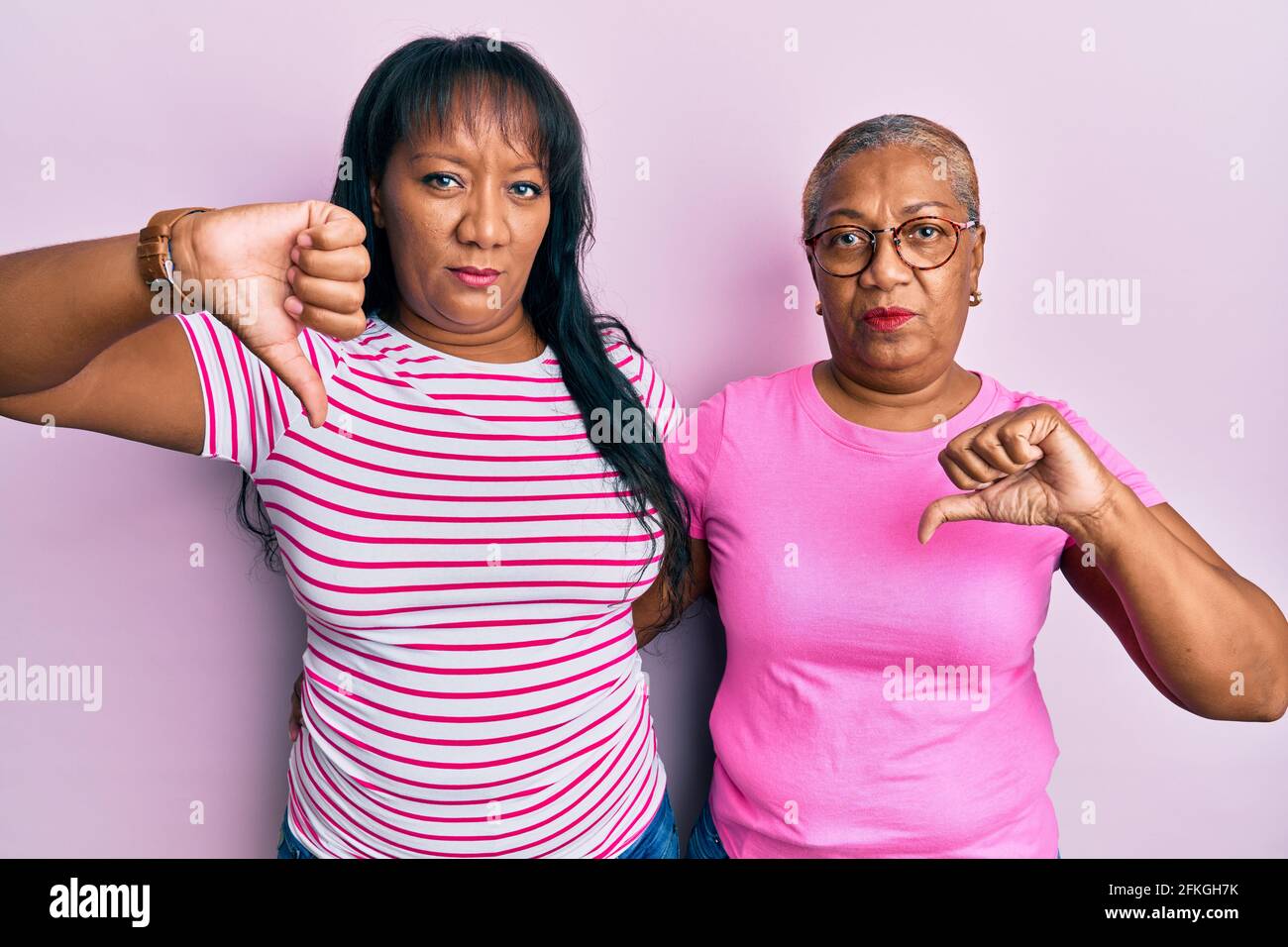 Hispanic family of mother and daughter hugging together with love with ...