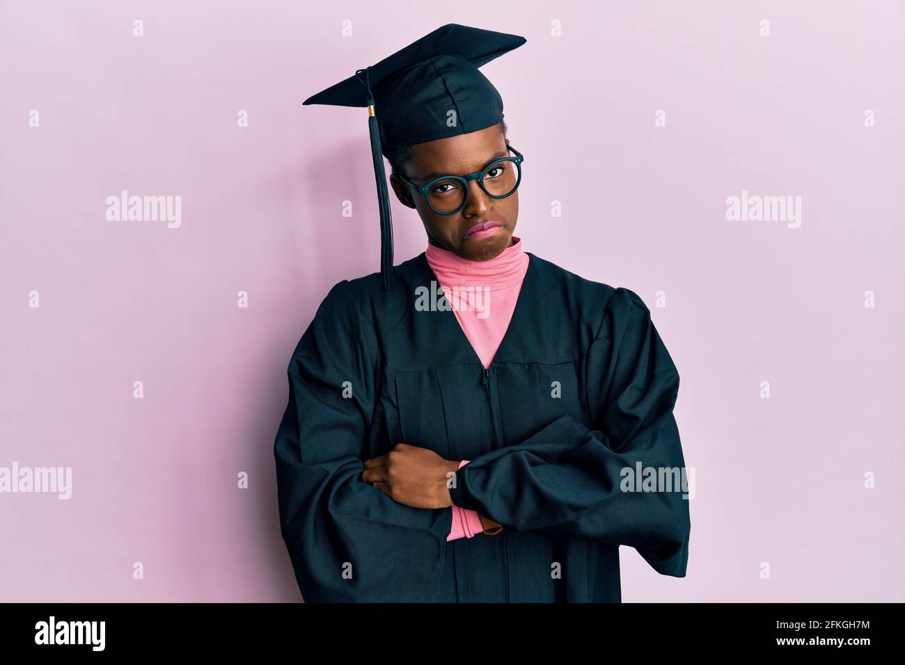 Young african american girl wearing graduation cap and ceremony robe ...