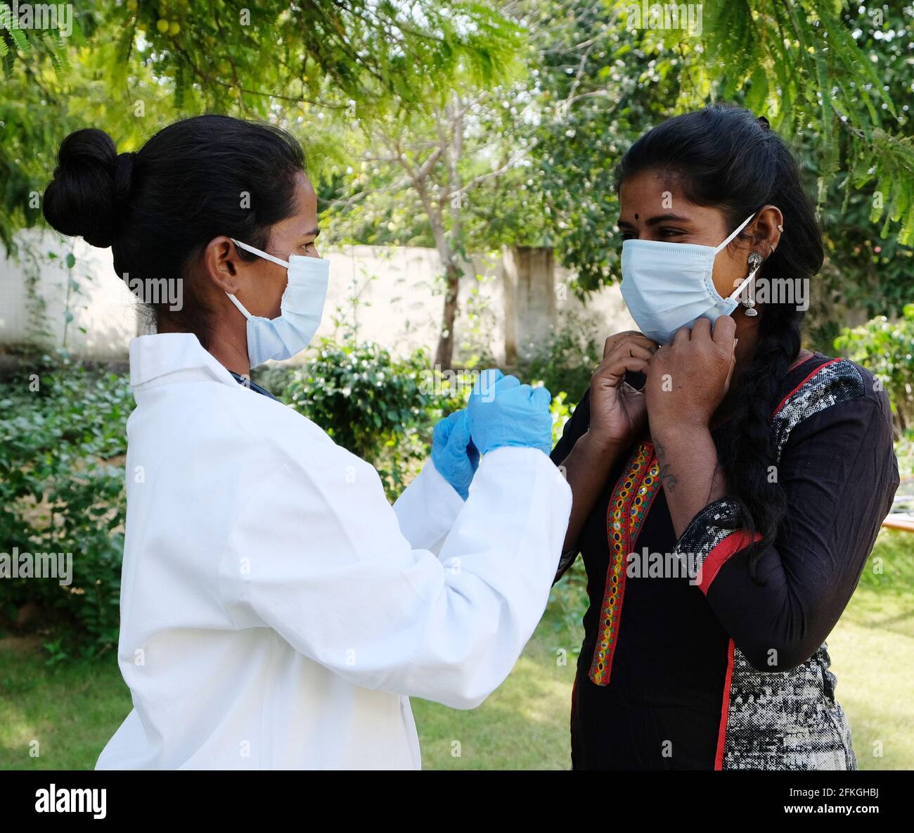 Indian female doctor giving instructions on how to wear a medical face ...