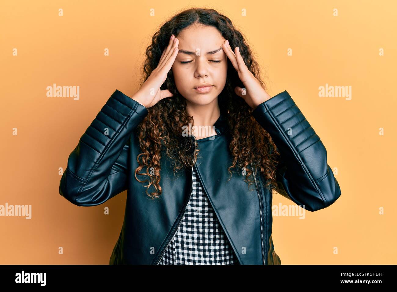 Teenager hispanic girl wearing black leather jacket suffering from ...