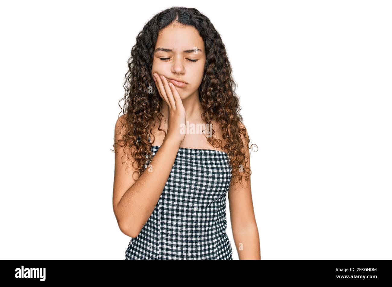Teenager hispanic girl wearing casual clothes touching mouth with hand ...