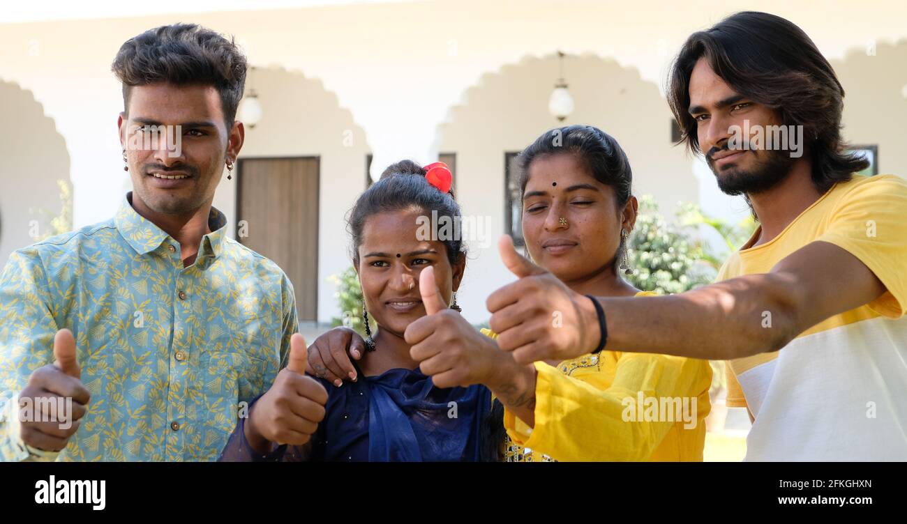 Group of happy smiling young Indian friends standing outdoors showing ...