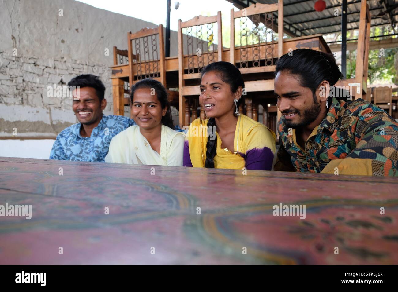 Group of cheerful young Indian friends enjoying their time in a cafe ...