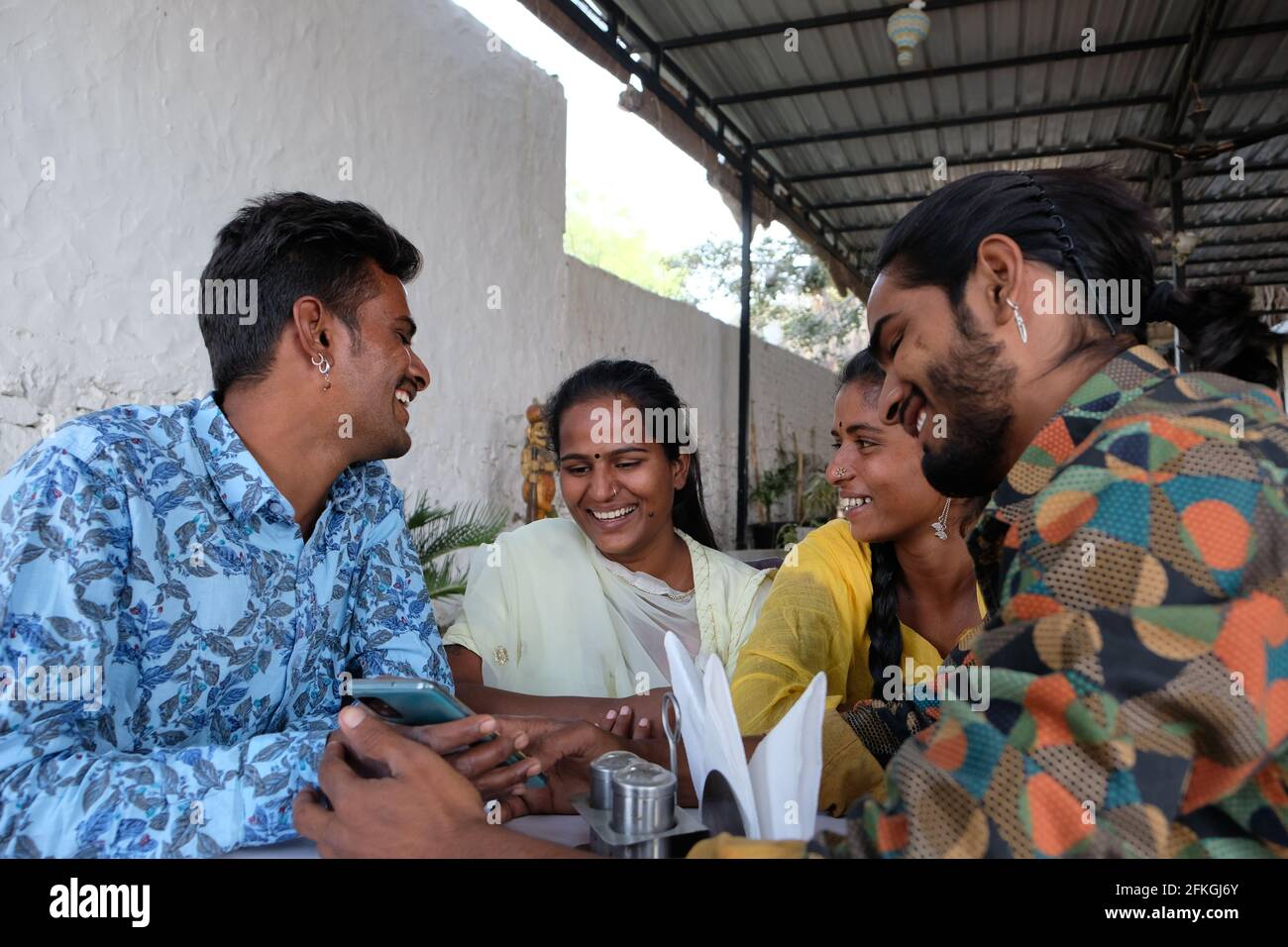 Group of happy cheerful young Indian friends having fun in a cafe Stock ...