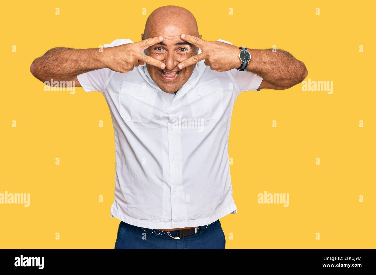 Mature middle east man with mustache wearing casual white shirt doing ...