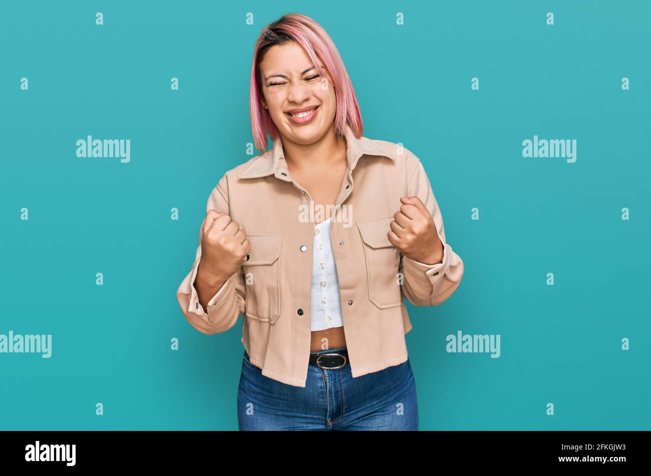 Hispanic Woman With Pink Hair Wearing Casual Clothes Very Happy And