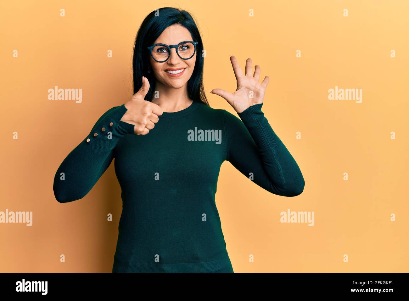 Young caucasian woman wearing casual clothes and glasses showing and ...