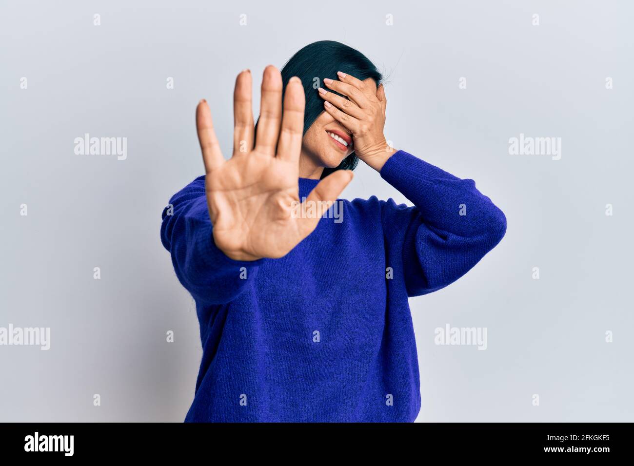 Young caucasian woman wearing casual clothes covering eyes with hands ...