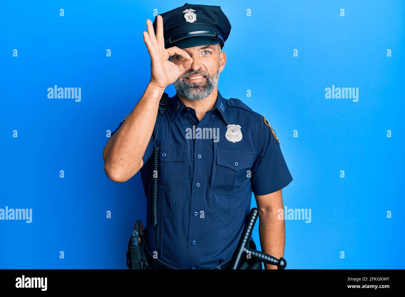 Middle age handsome man wearing police uniform doing ok gesture with ...