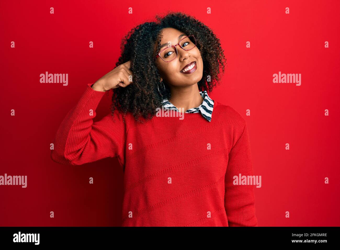 Beautiful african american woman with afro hair wearing sweater and ...
