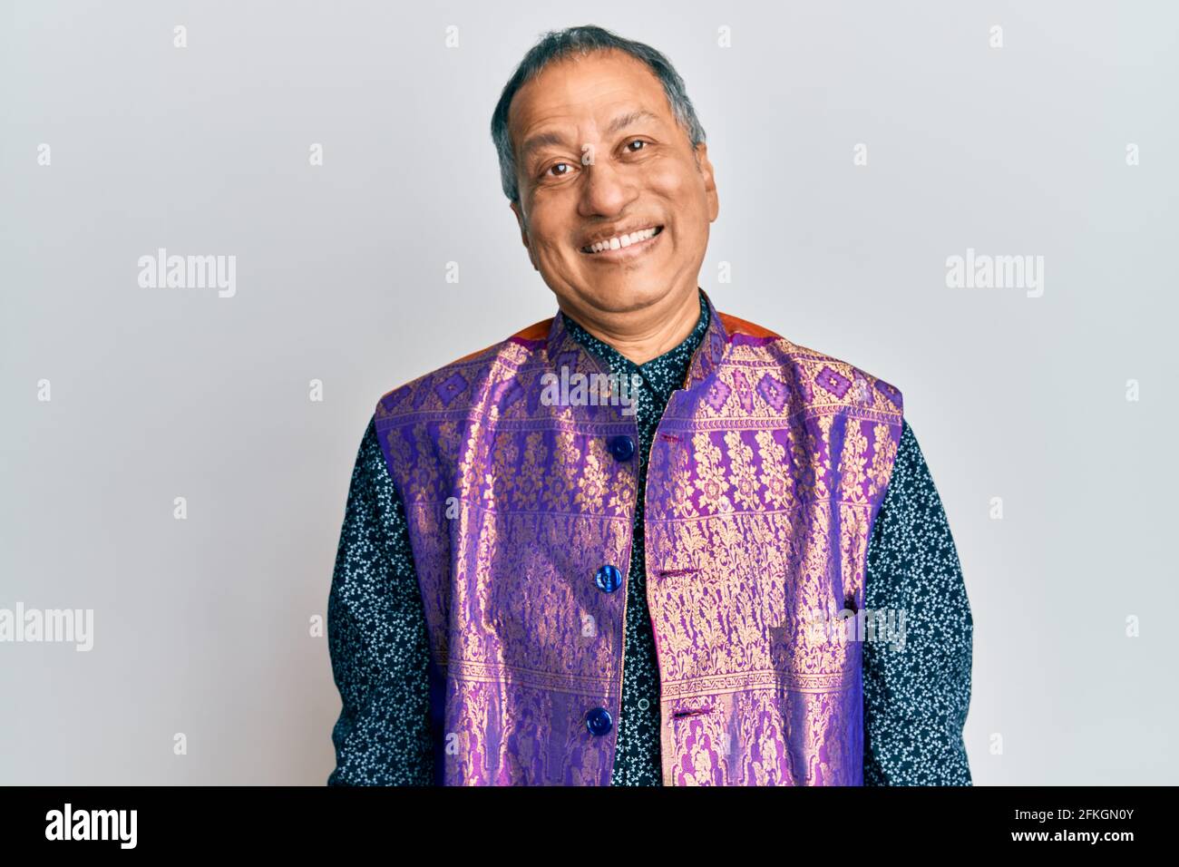 Middle age indian man wearing traditional indian clothes with a happy ...