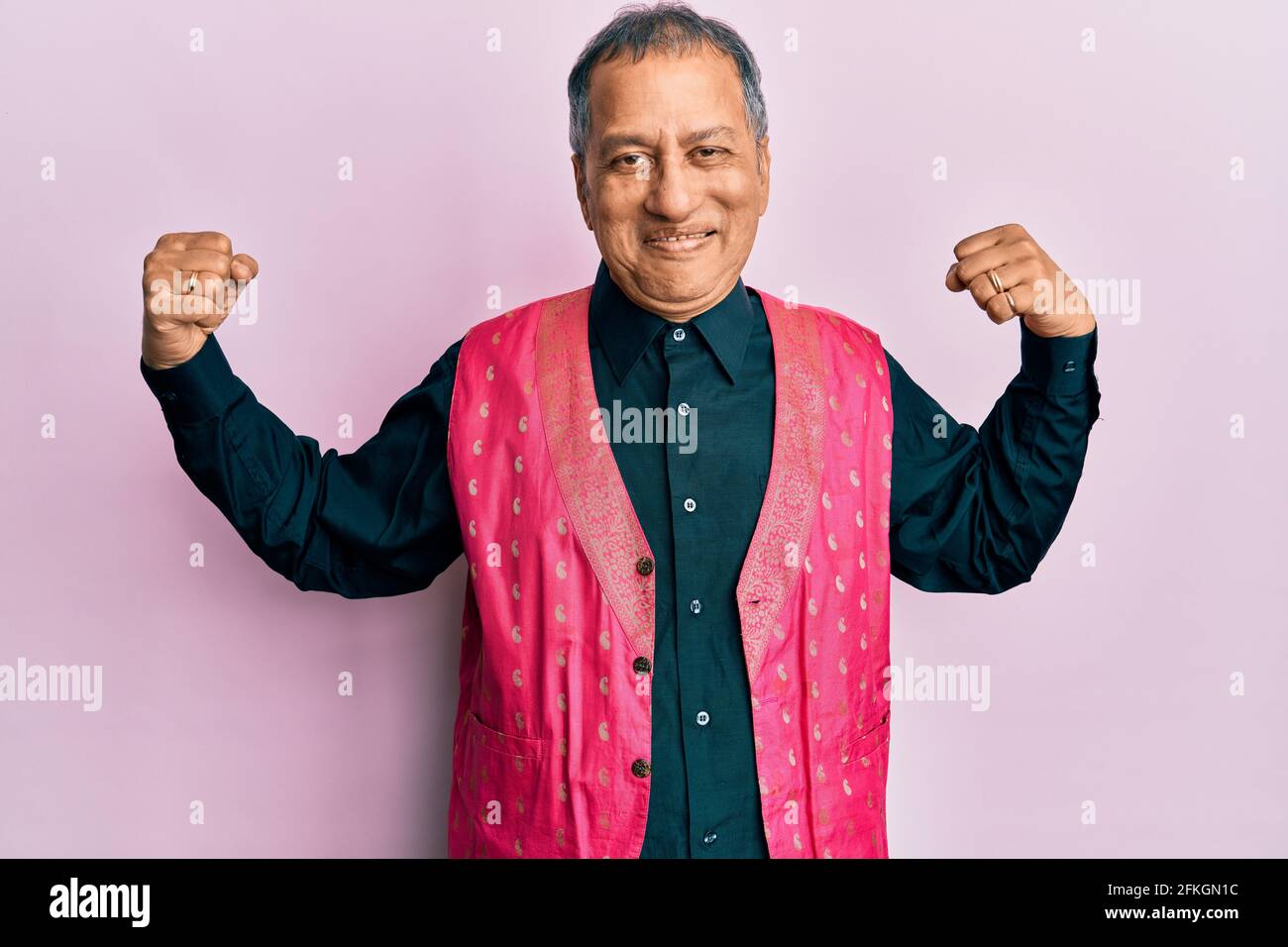 Middle age indian man wearing traditional indian clothes showing arms ...