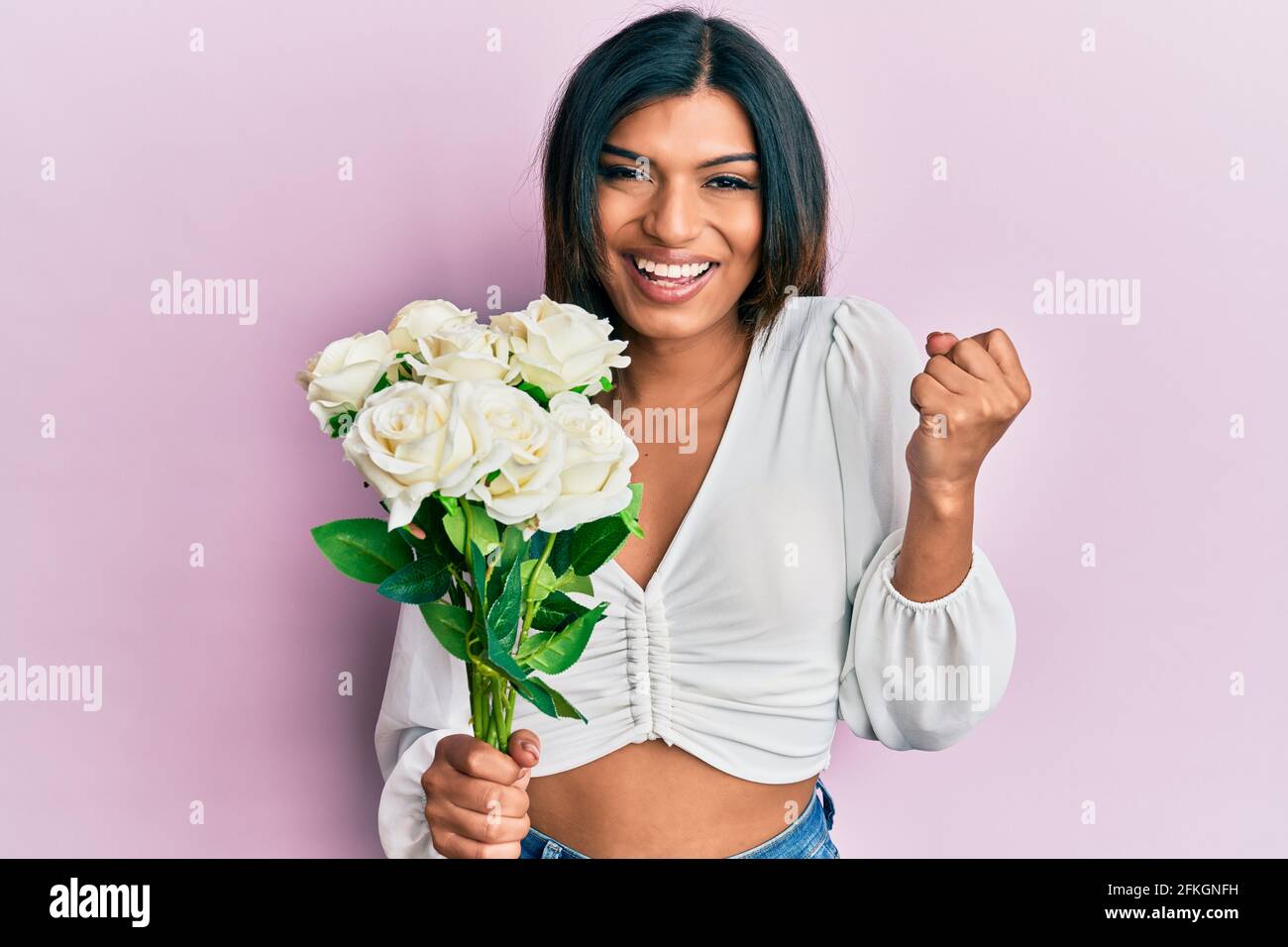Young latin transsexual transgender woman holding flowers screaming ...