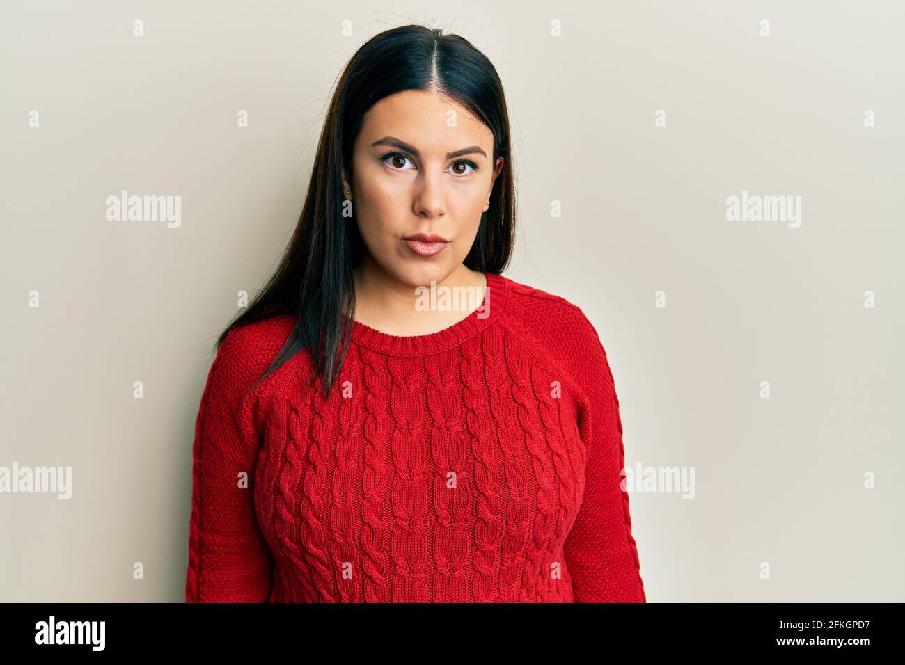 Beautiful brunette woman wearing wool winter sweater relaxed with ...