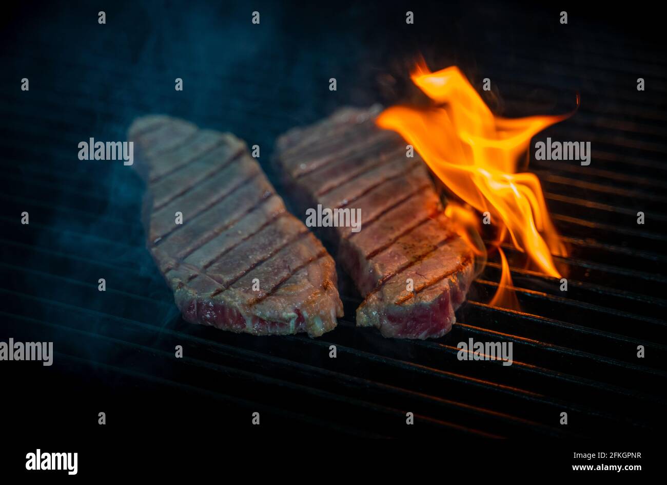 Turning half cooked meat pieces hi-res stock photography and images - Alamy