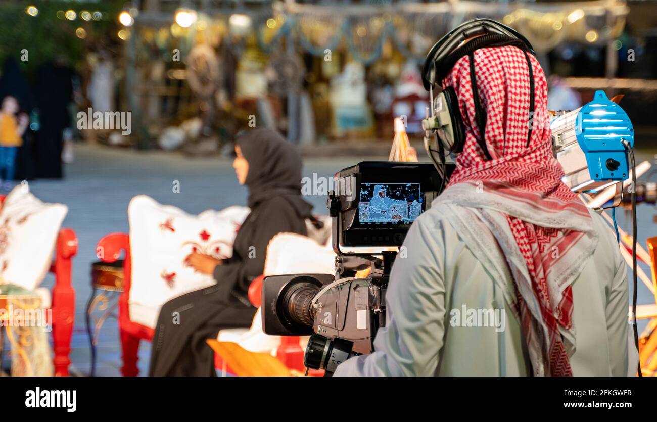 An Arab man recording a live interview video at an outdoor event in ...