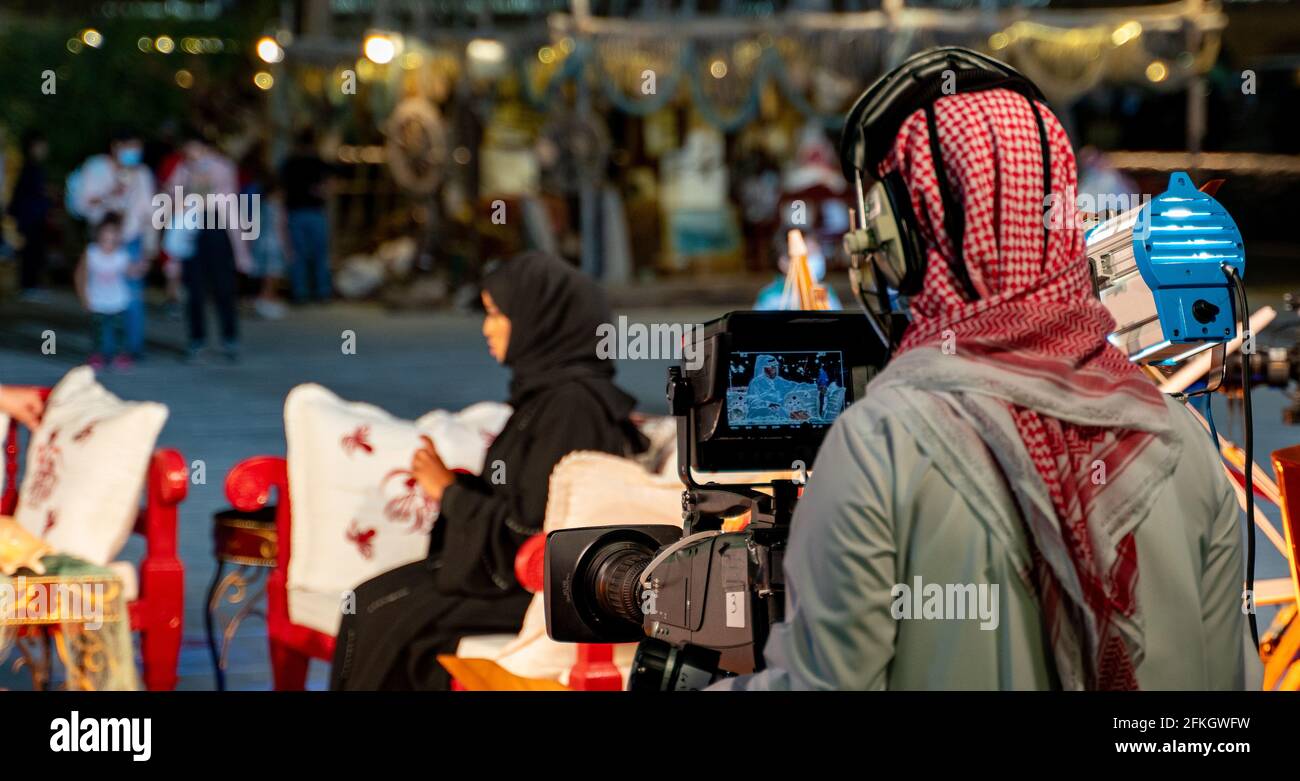 An Arab man recording a live interview video at an outdoor event in ...