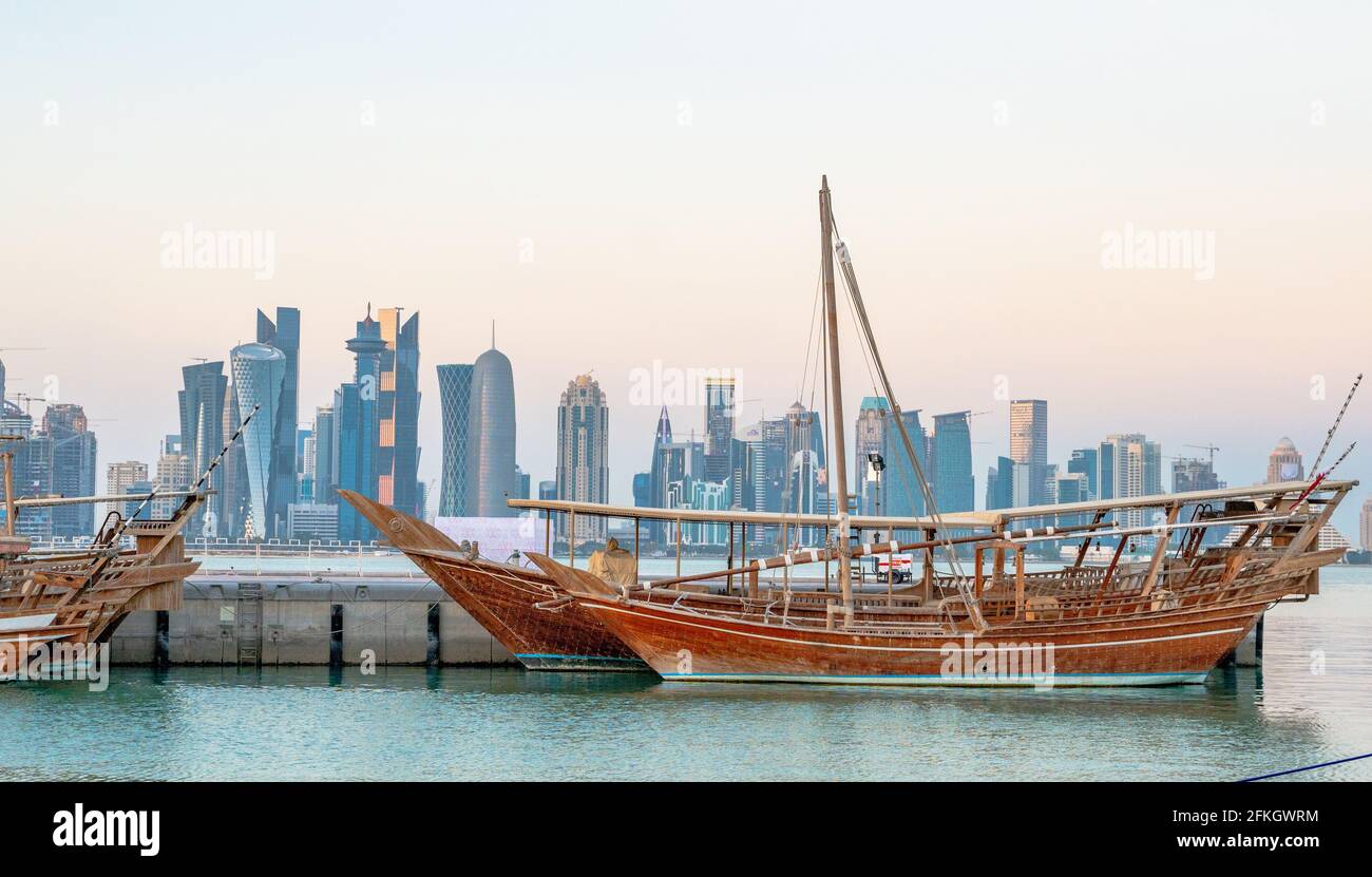 Traditional Arabic Dhow boats along with Doha skyline. Selective focus ...