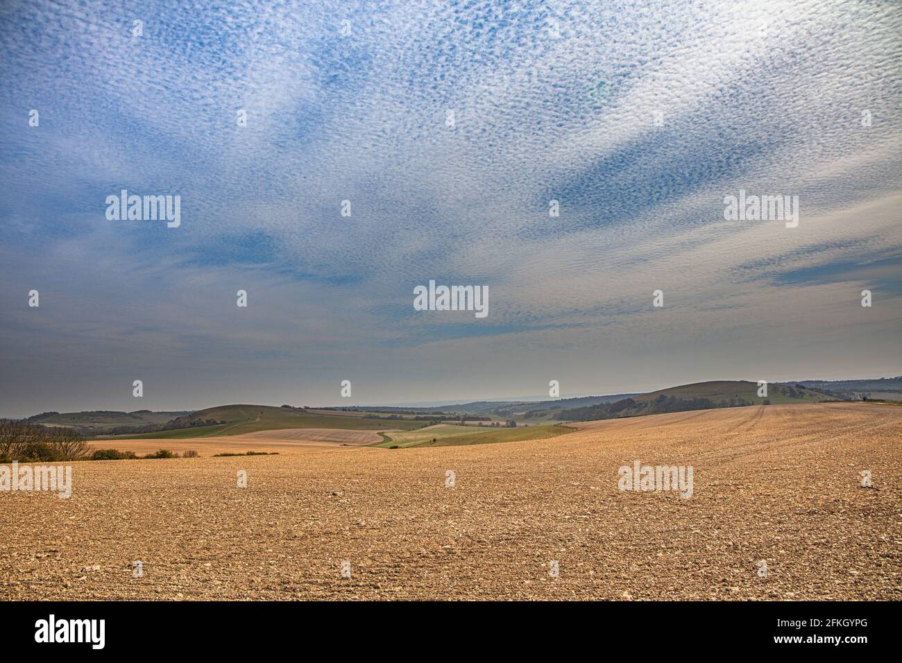 Vast empty wasteland beneath small clouds filling the sky Stock Photo ...