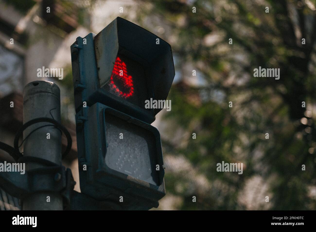 Closeup shot of an illuminated red hand sign on a pedestrian light ...