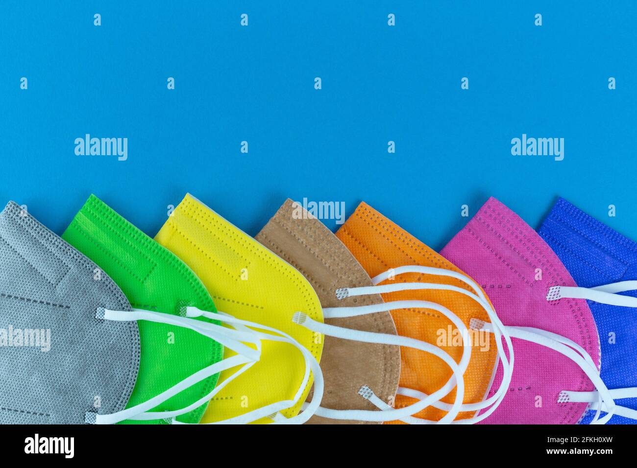 stack of different colors FFP2 or N95 face masks respirators without ...