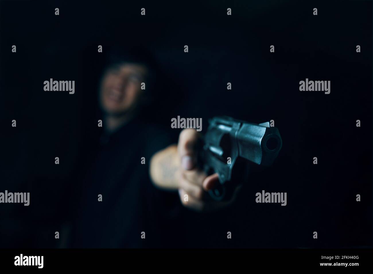 Man threatens with firearm. Revolver in person's hands. Criminal with a ...