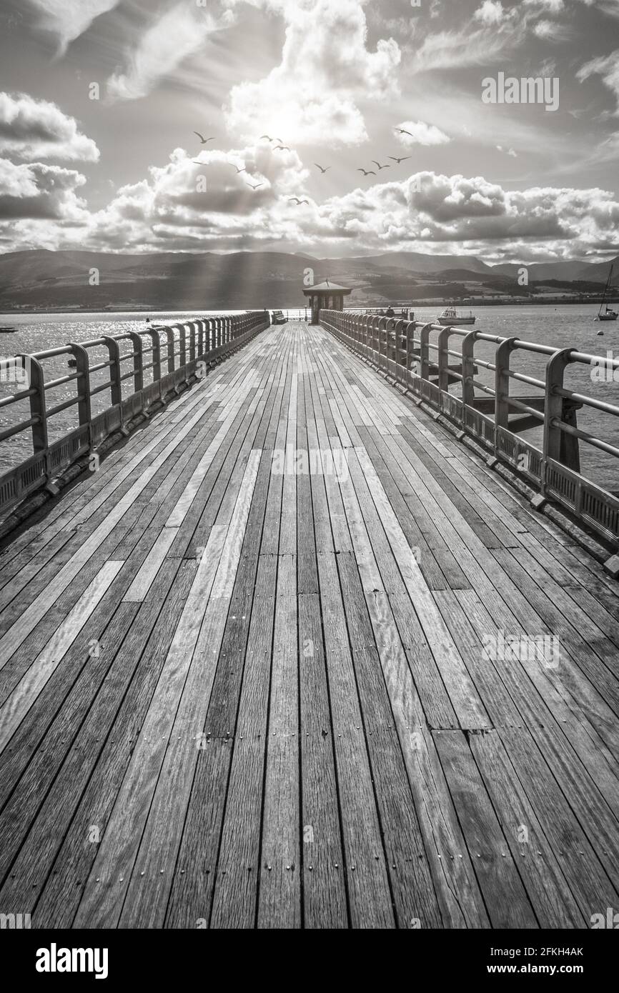 Beaumaris pier. Anglesey, North Wales against the sun with the ...