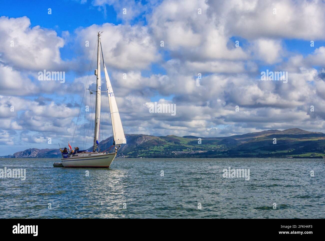 Yacht sailing in the Menai Straits bewteen Anglesey and the Welsh ...