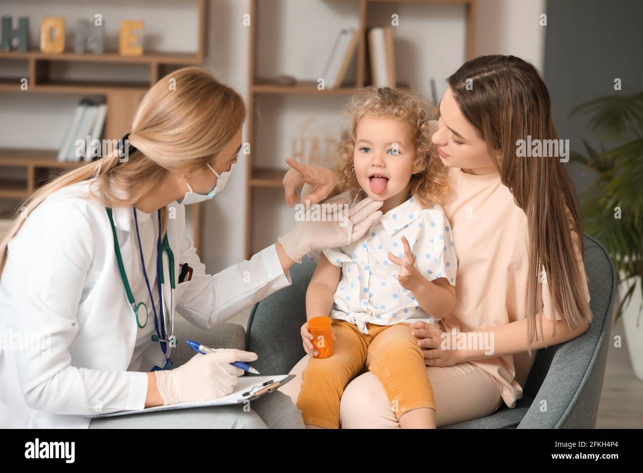Pediatrician examining little girl at home Stock Photo - Alamy