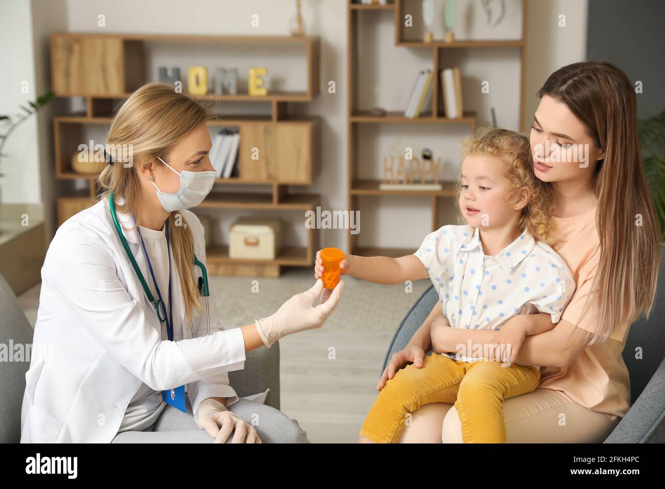 Pediatrician giving medicine to little girl at home Stock Photo - Alamy