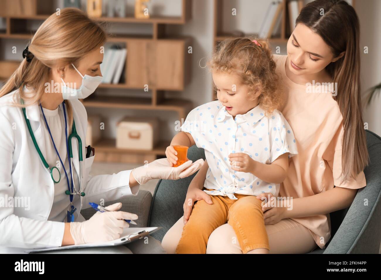 Pediatrician giving medicine to little girl at home Stock Photo - Alamy