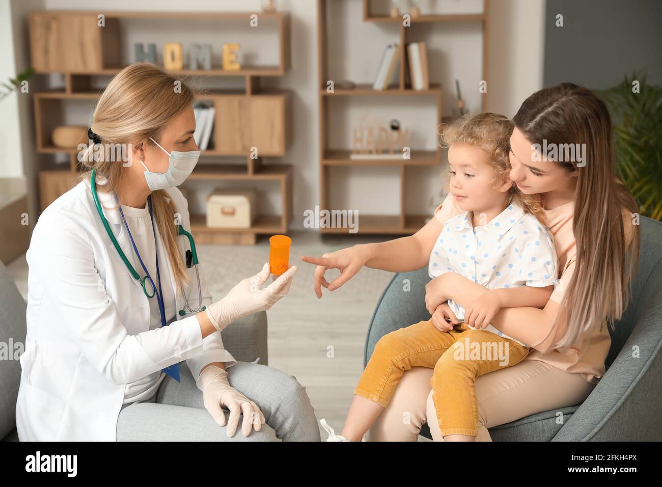 Pediatrician giving medicine to little girl at home Stock Photo - Alamy