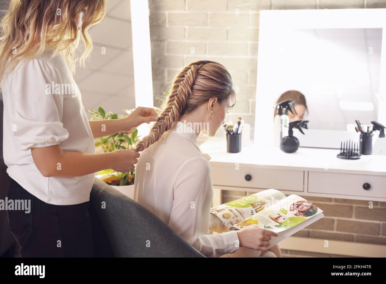 Hairdresser working with client in beauty salon Stock Photo - Alamy