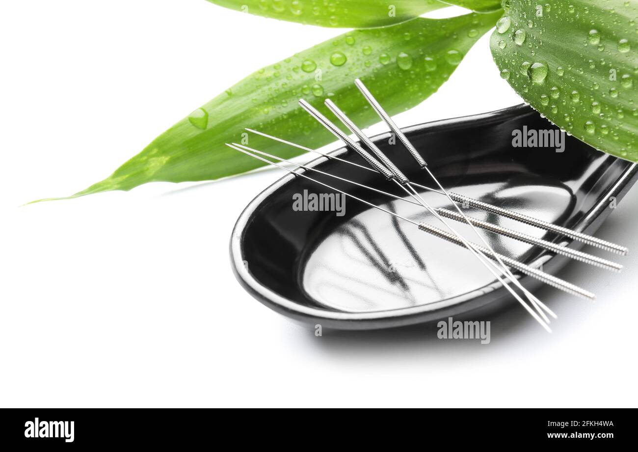 Stand with acupuncture needles on white background Stock Photo - Alamy