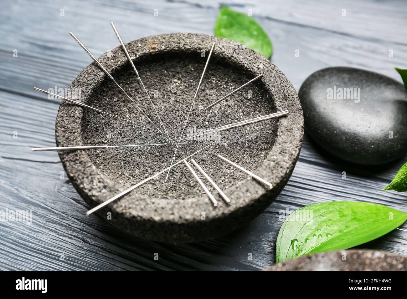 Stand with acupuncture needles on wooden background Stock Photo - Alamy