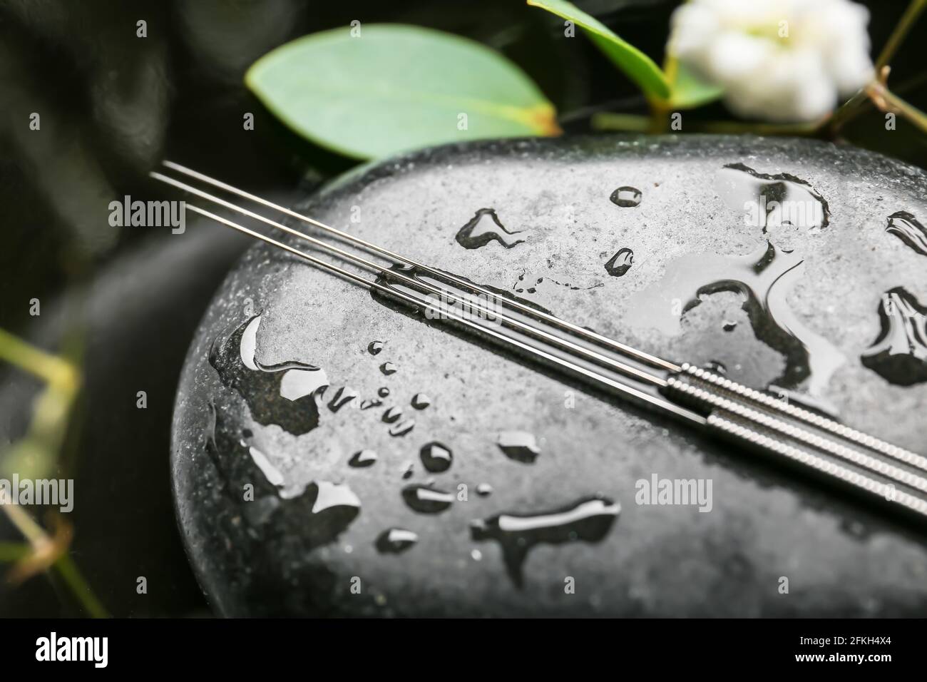 Acupuncture needles on spa stone, closeup Stock Photo - Alamy