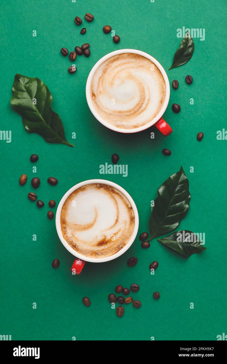Cups of hot cappuccino on color background Stock Photo - Alamy