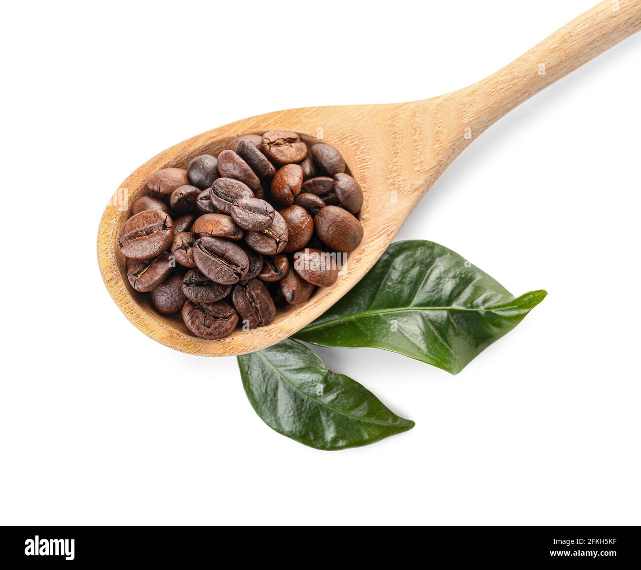 Spoon with coffee beans on white background Stock Photo - Alamy