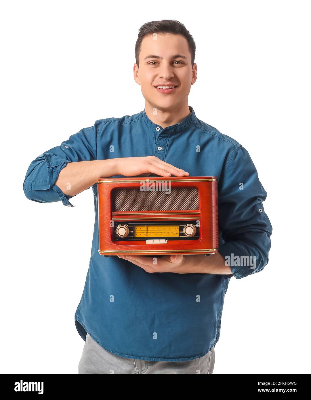 Young man with retro radio receiver on white background Stock Photo - Alamy