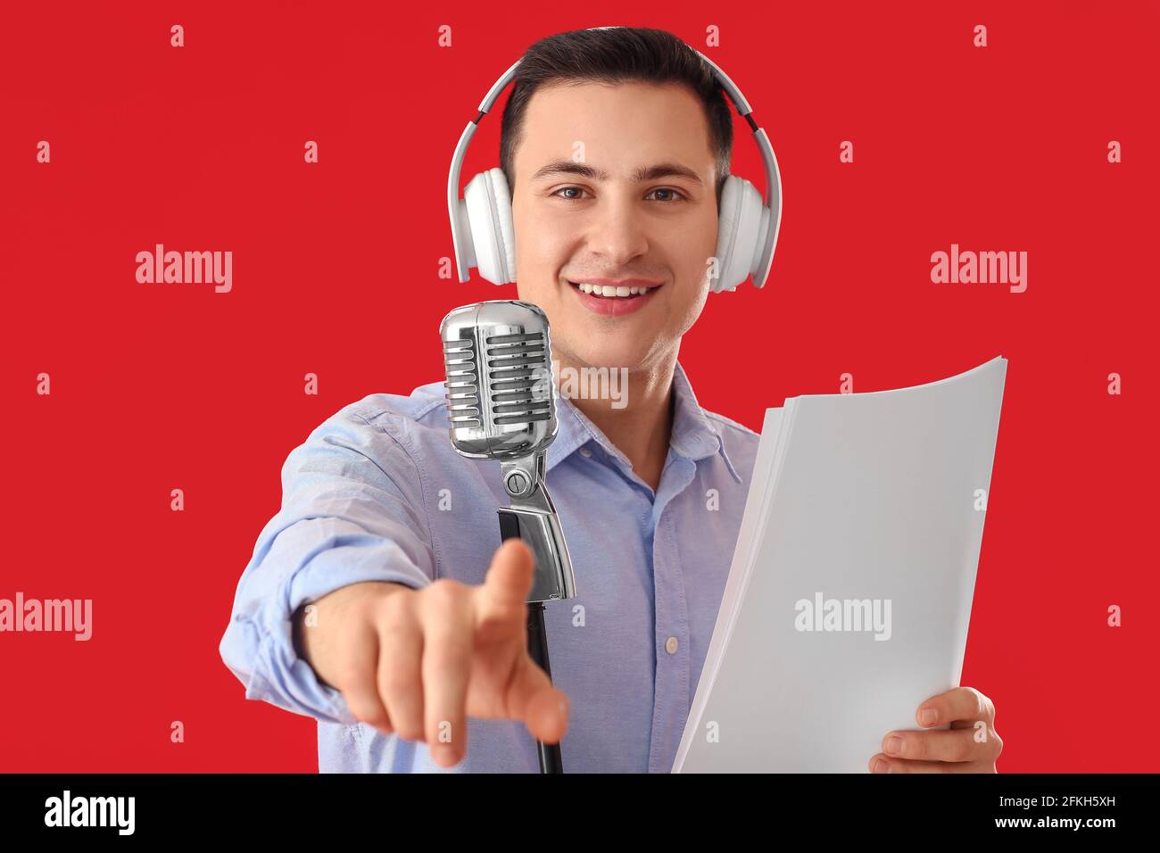 Male radio presenter with microphone on color background Stock Photo ...
